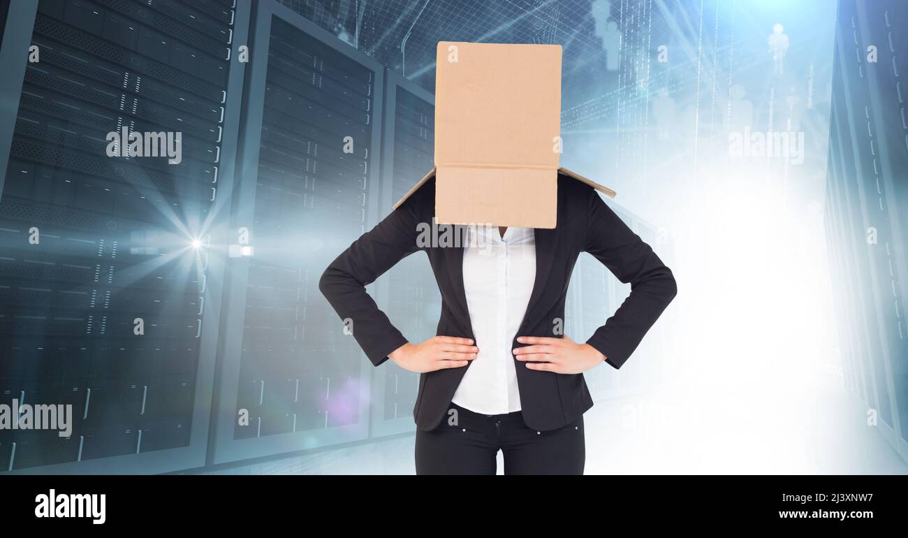 Cardboard box over the head of businesswoman against spot of light and ...