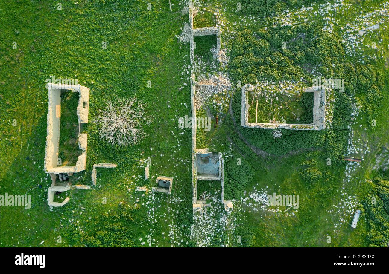 Ruins of traditional stone buildings in abandoned village, drone view ...