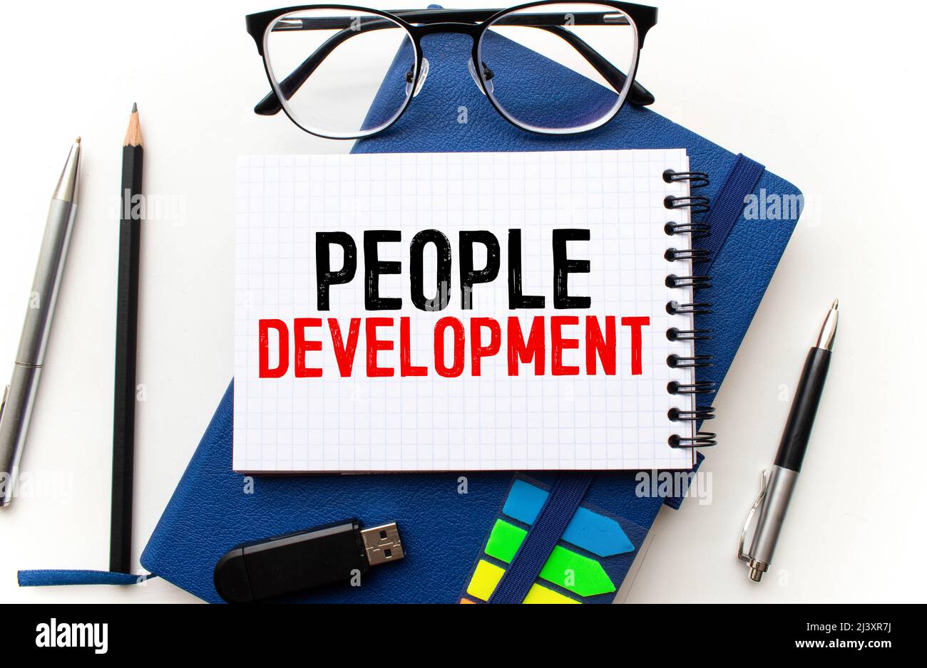 Business and finance concept.Text PEOPLE DEVELOPMENT with pen,compass ...
