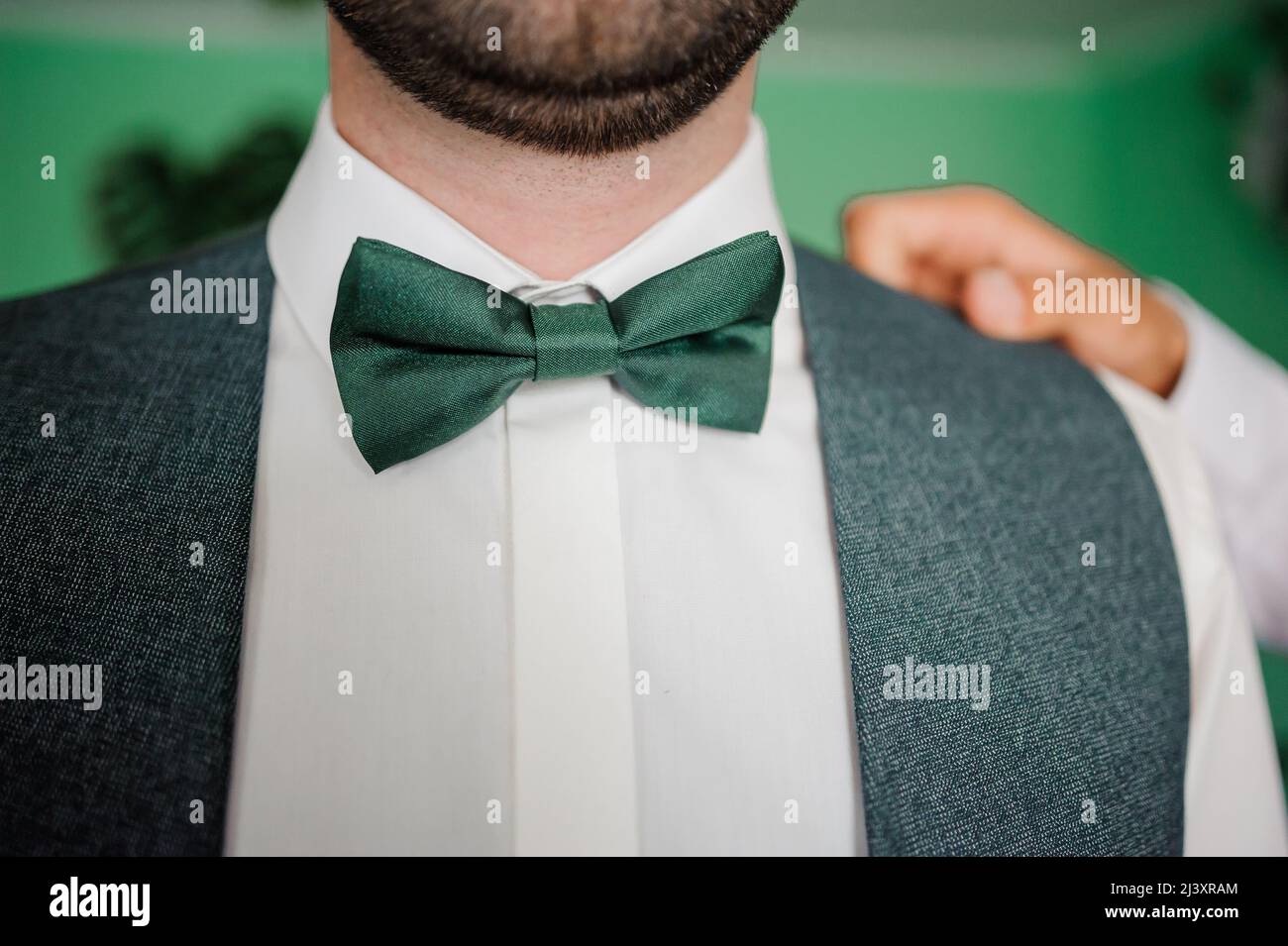 Green bow tie around the neck of a man. Wedding Stock Photo - Alamy