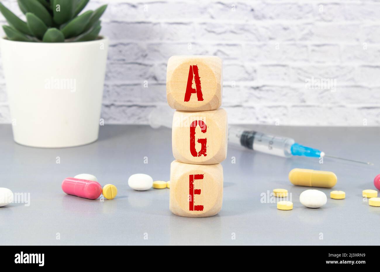 AGE - word from wooden blocks with letters, magnifier, aging concept ...