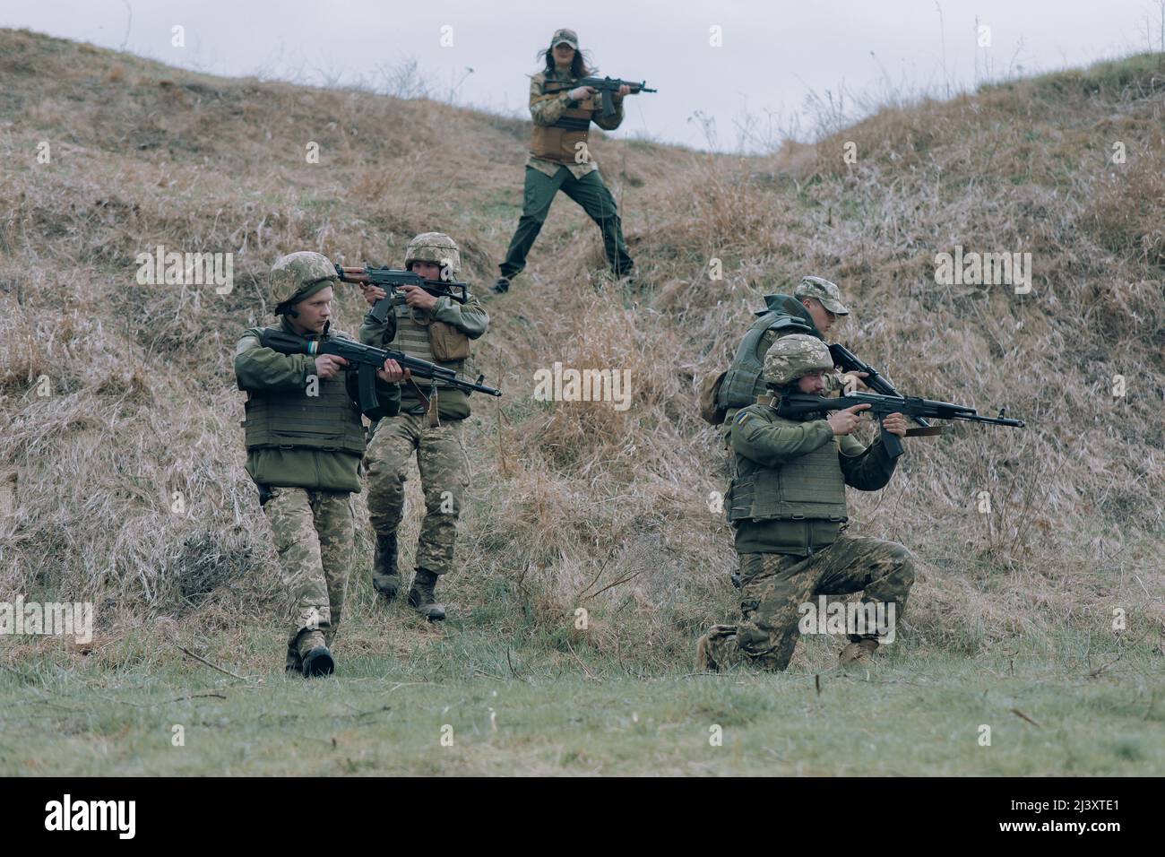 Team of five Ukrainian soldiers aims from kalashnikov assault rifles to ...