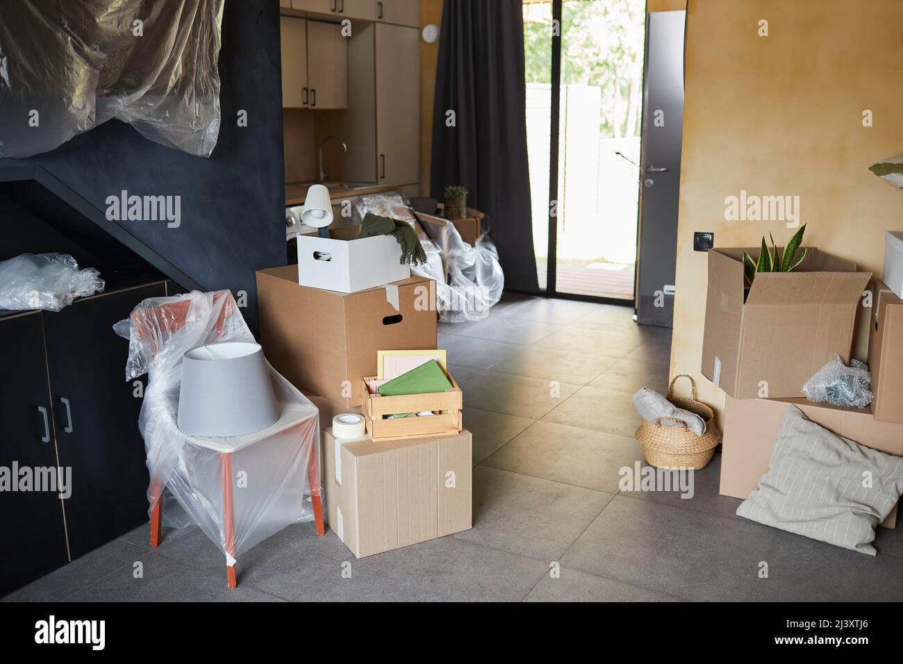 Background image of messy cardboard boxes in new home, family moving ...