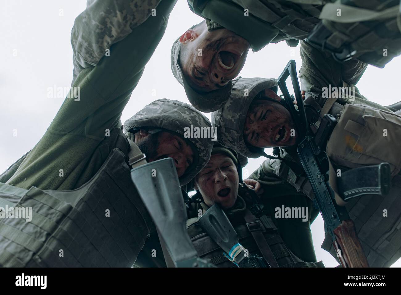 Four Ukrainian soldiers embrace each other and scream in rage against ...