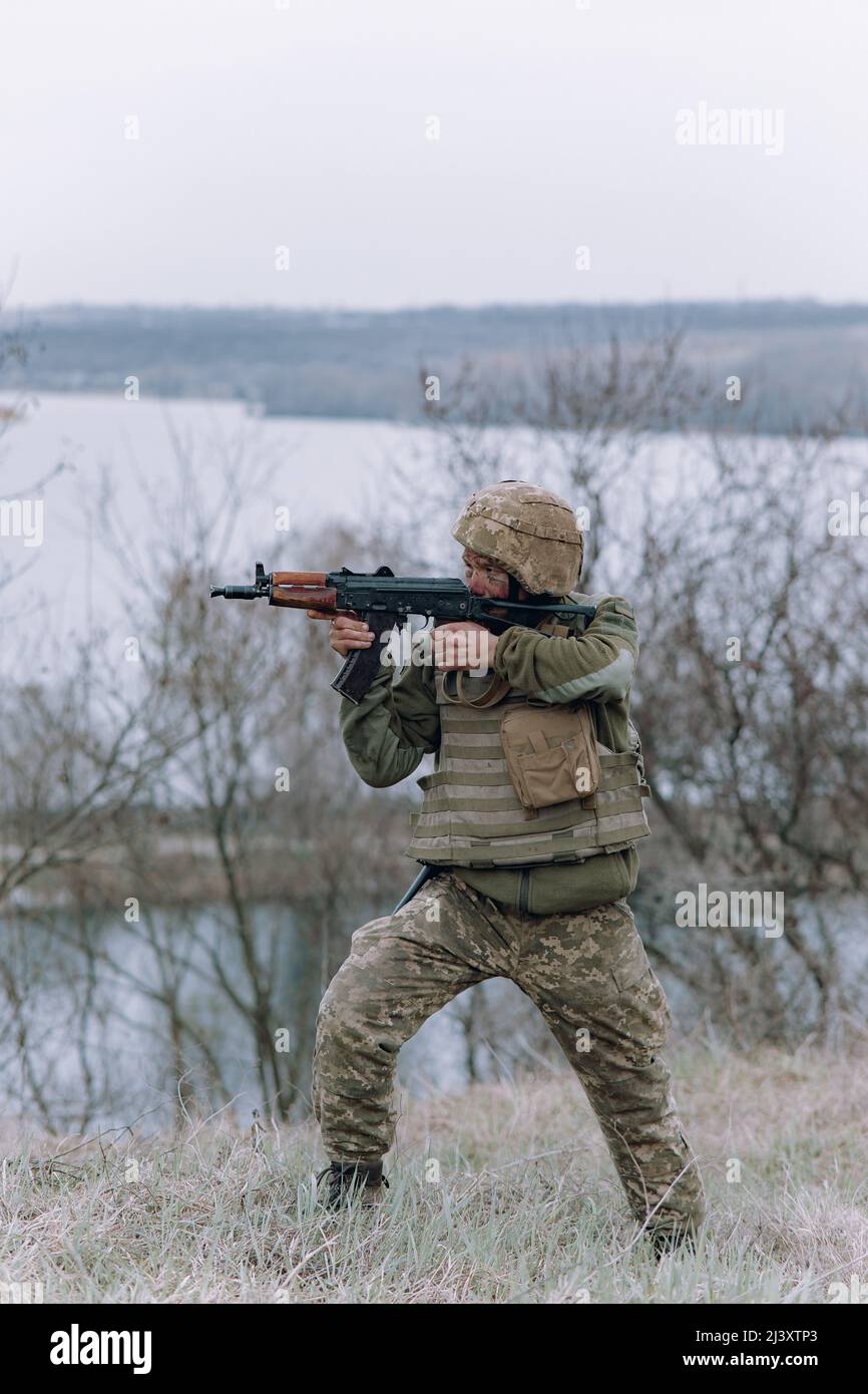 Ukrainian soldier aims from kalashnikov assault rifle to russian enemy ...