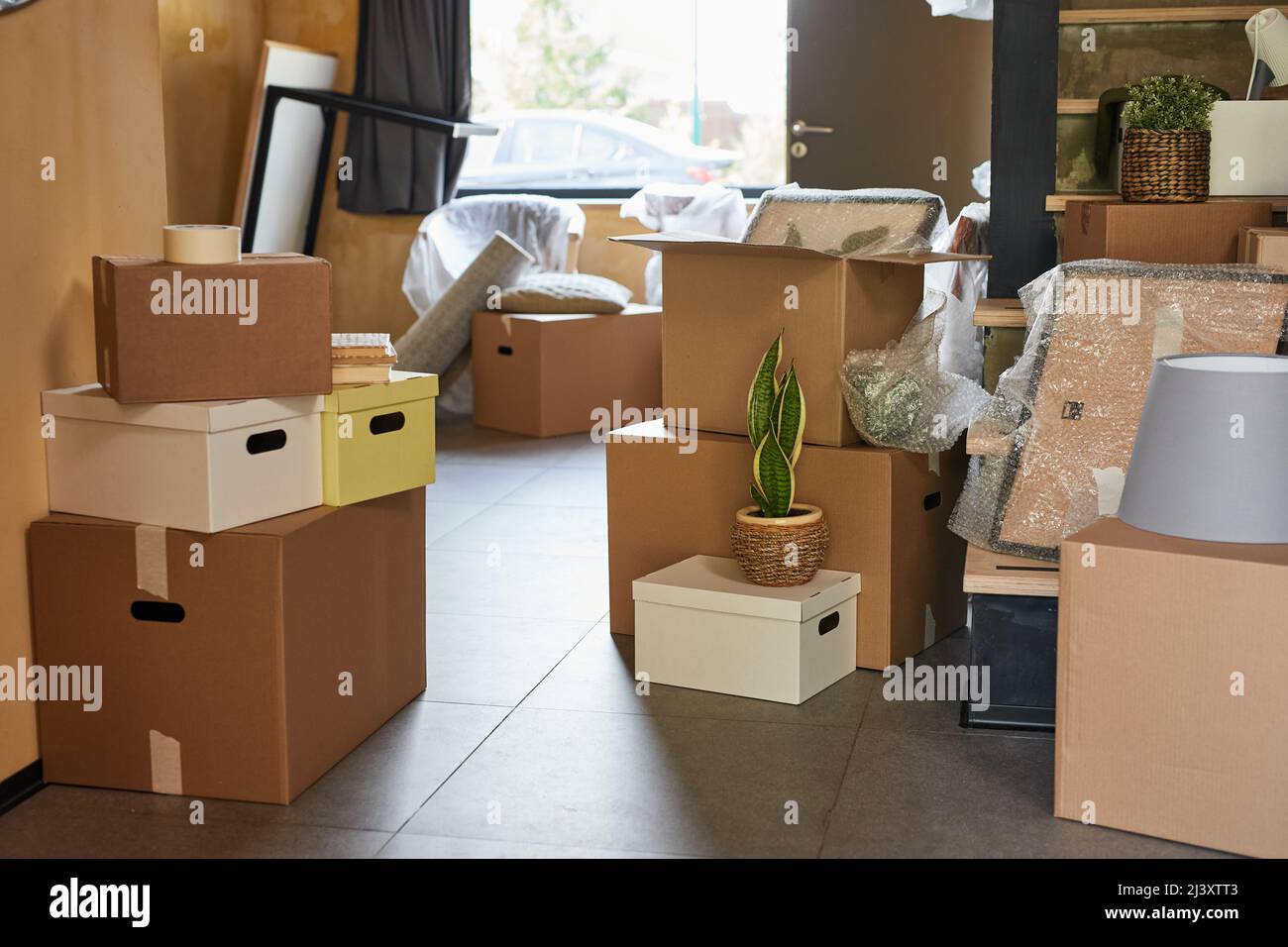 Background image of hallway in new home filled with cardboard boxes ...