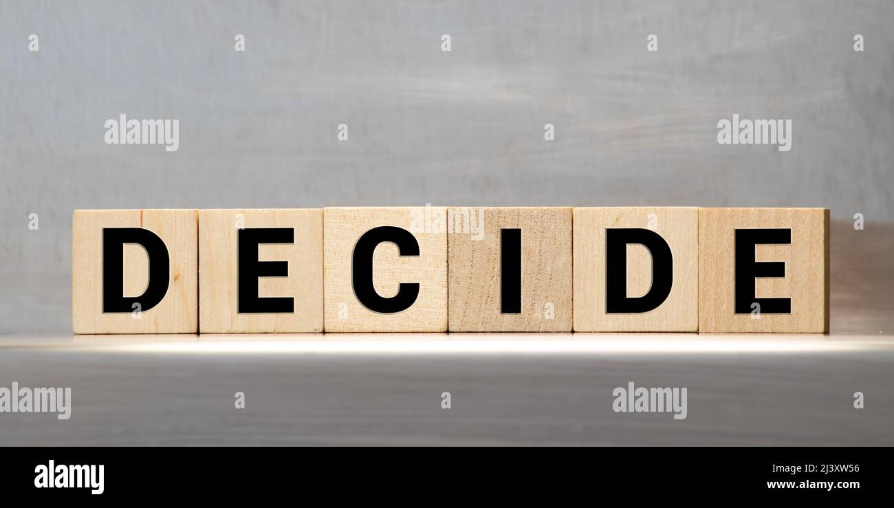 Decide word on wooden cubes, business concept Stock Photo - Alamy