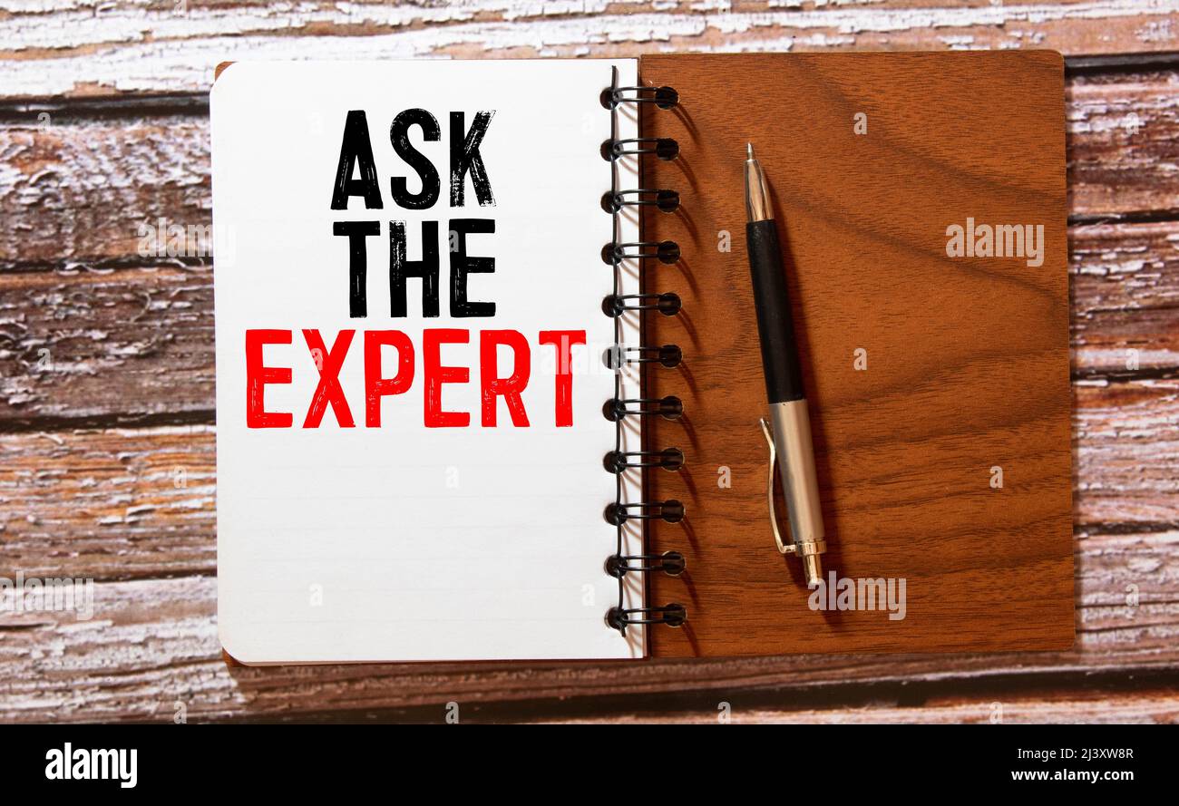 Ask the experts. Sticky note with ask the experts inscription pinned on ...
