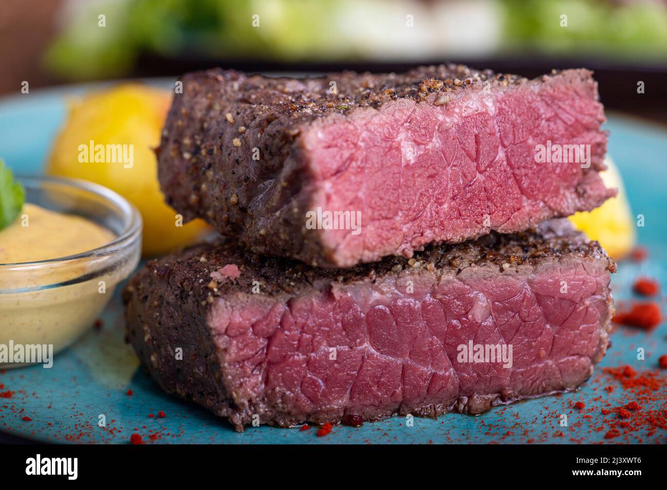 closeup of steak slices on a blue plate Stock Photo - Alamy