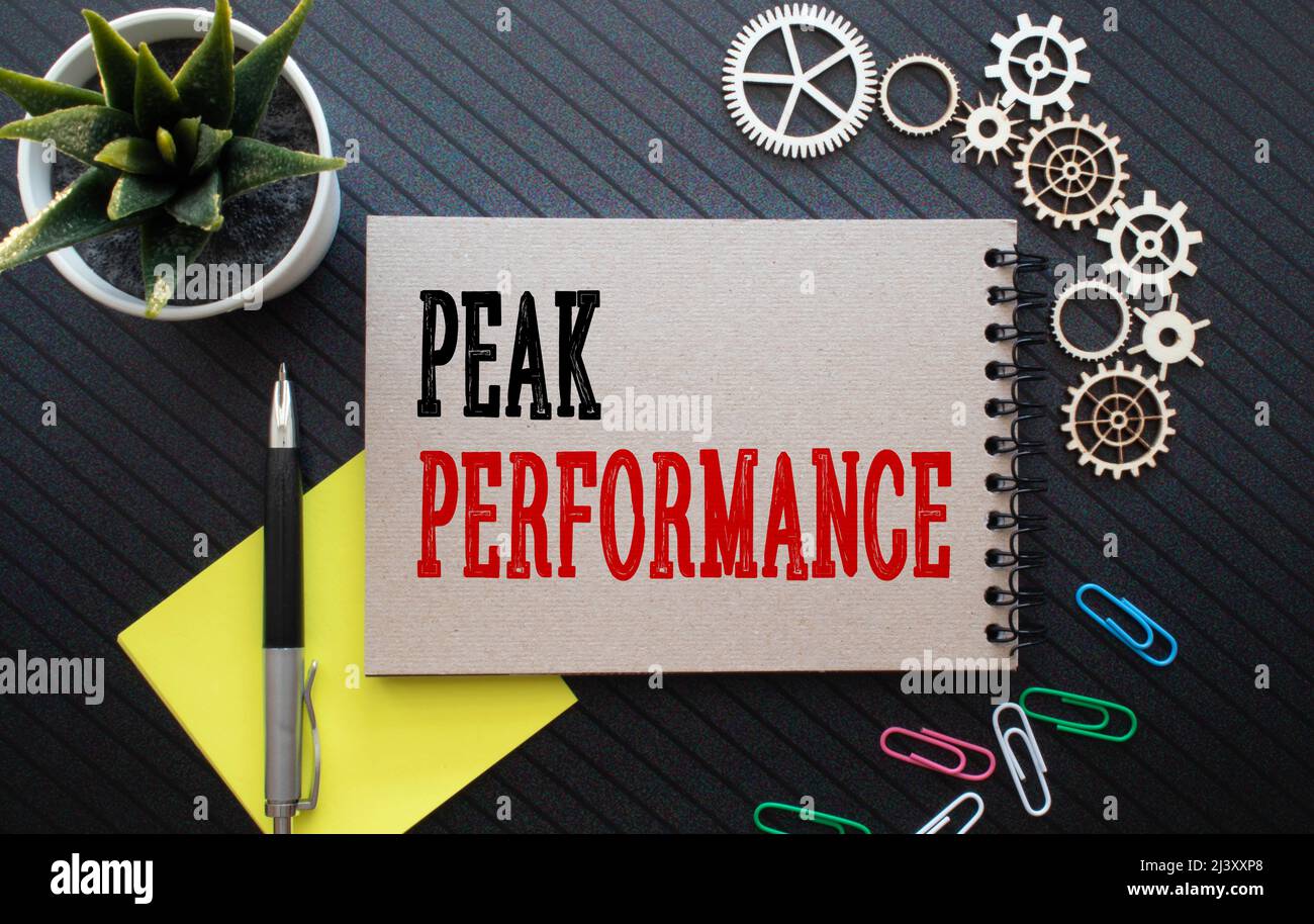 The text PEAK PERFORMANCE appearing behind torn white paper Stock Photo ...