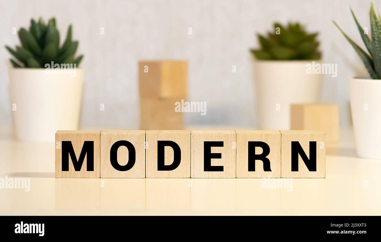 modern word written on wood block. modern text on cement table for your ...