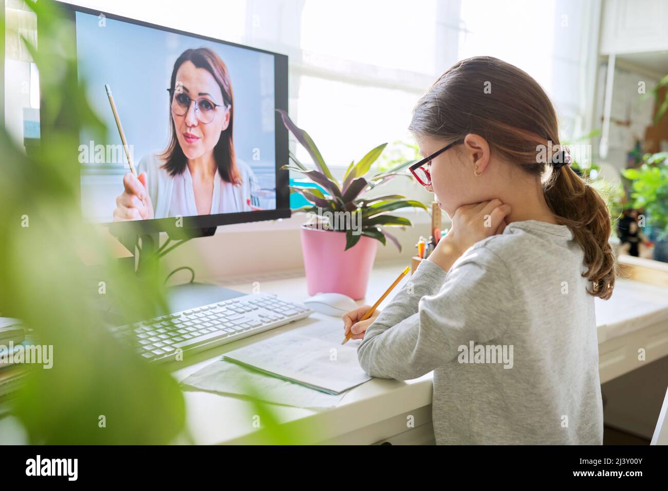 Child girl studying at home online using computer Stock Photo - Alamy