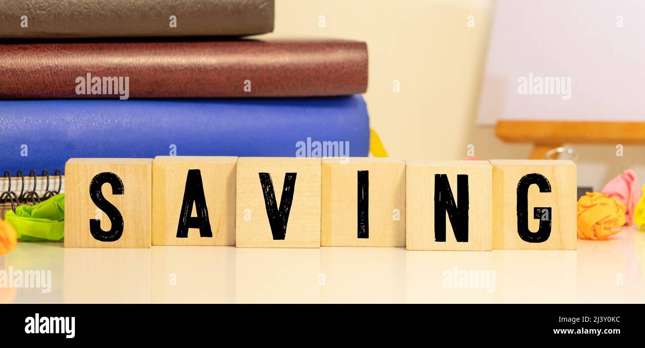 Savings word written with black letters on wooden cubes grouped as a ...