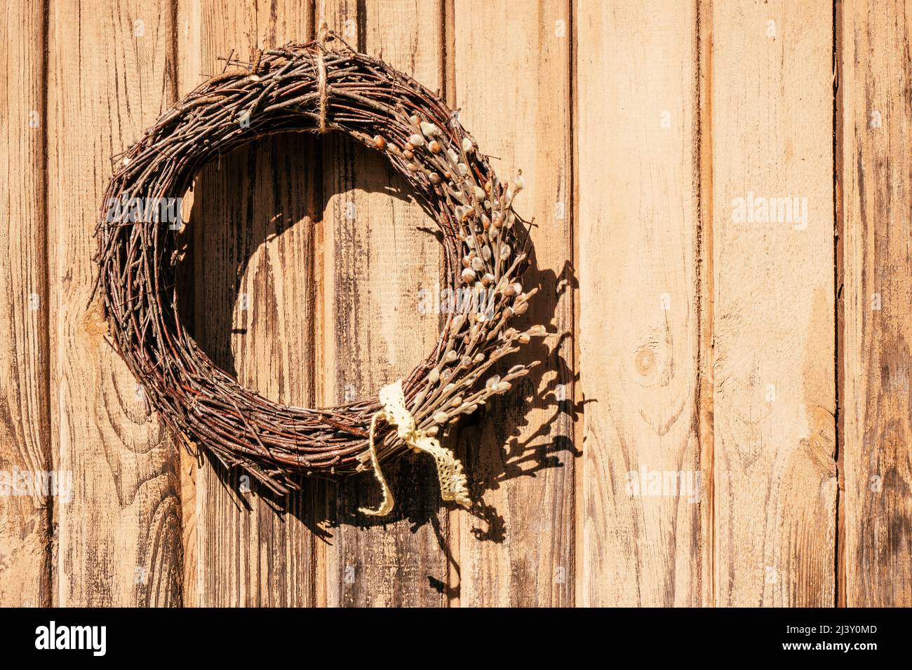 Tightly woven hanging willow wreath from wickers with decorative cotton ...