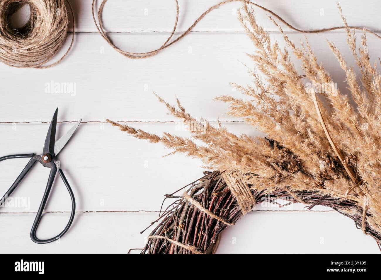 Dry herbal, cereal, spike tightly woven wreath. Skein of thread and ...