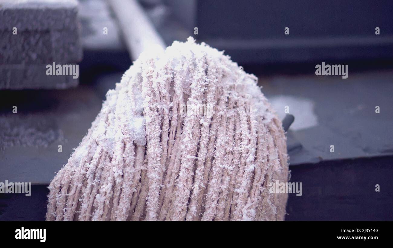 An icy mop is lying on board the ship in the evening. CLIP. The mop was ...