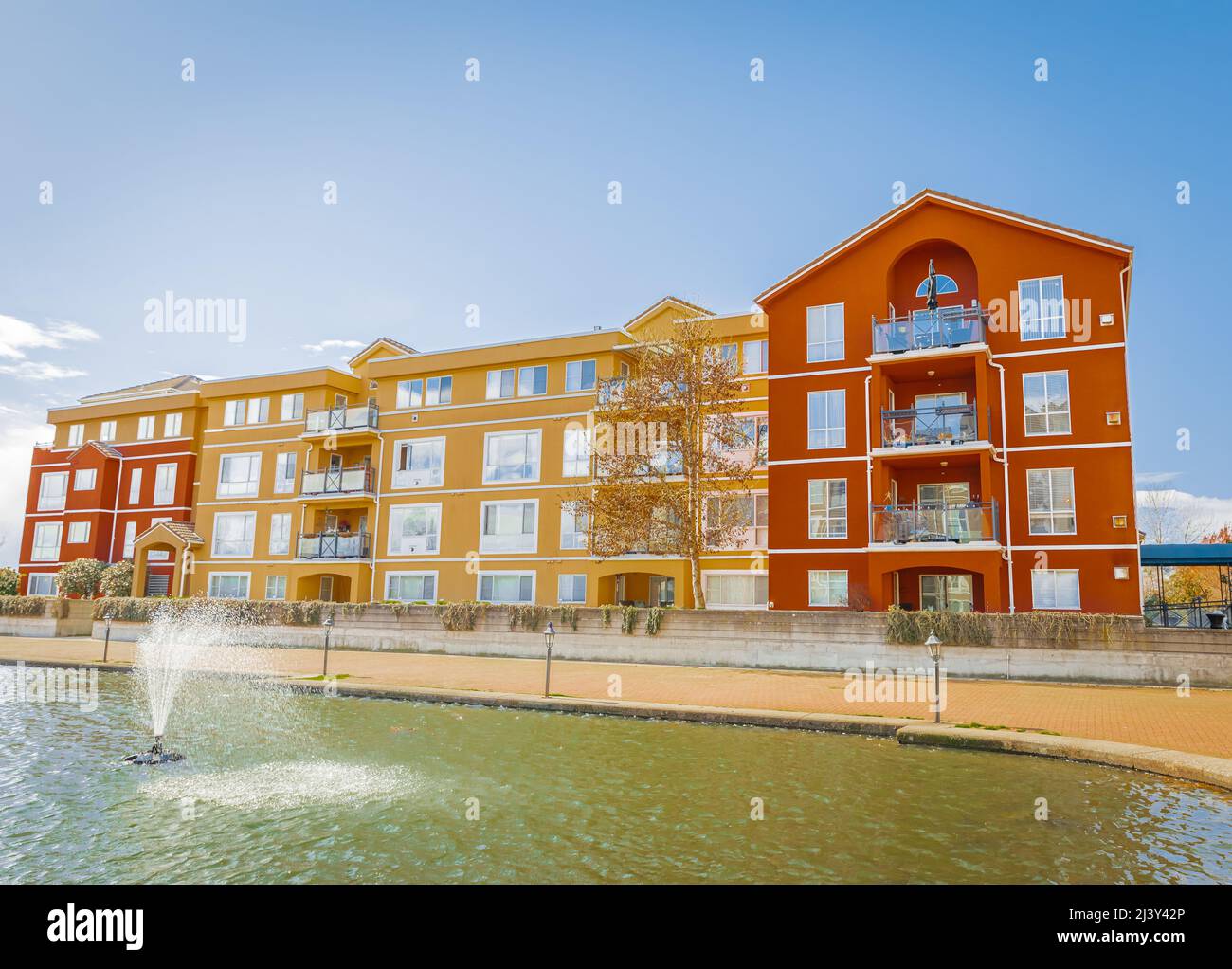 Neighborhood modern houses by waterfront on sunny day in New ...
