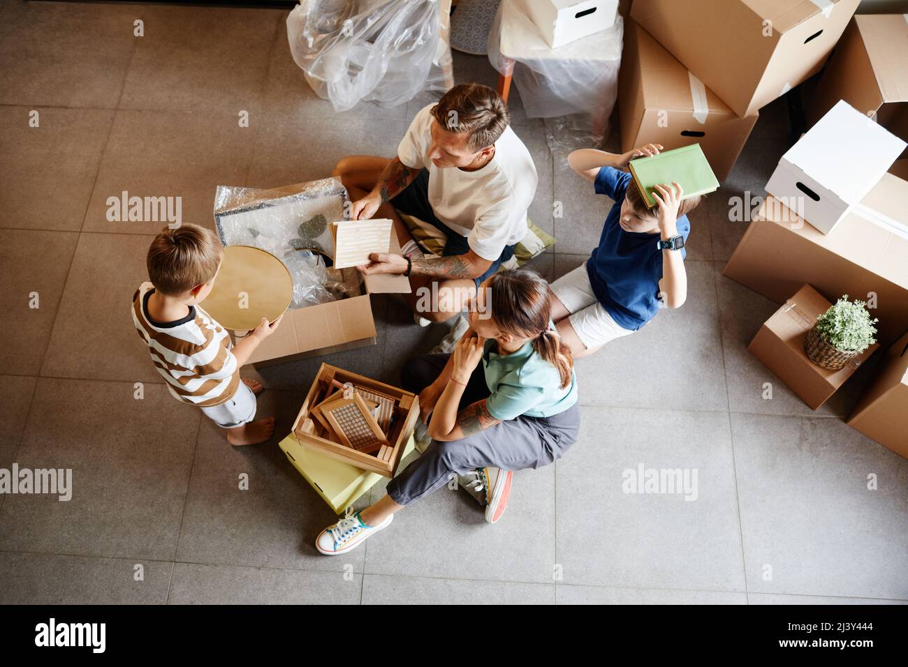 Top view portrait of family with two children moving into new house and ...