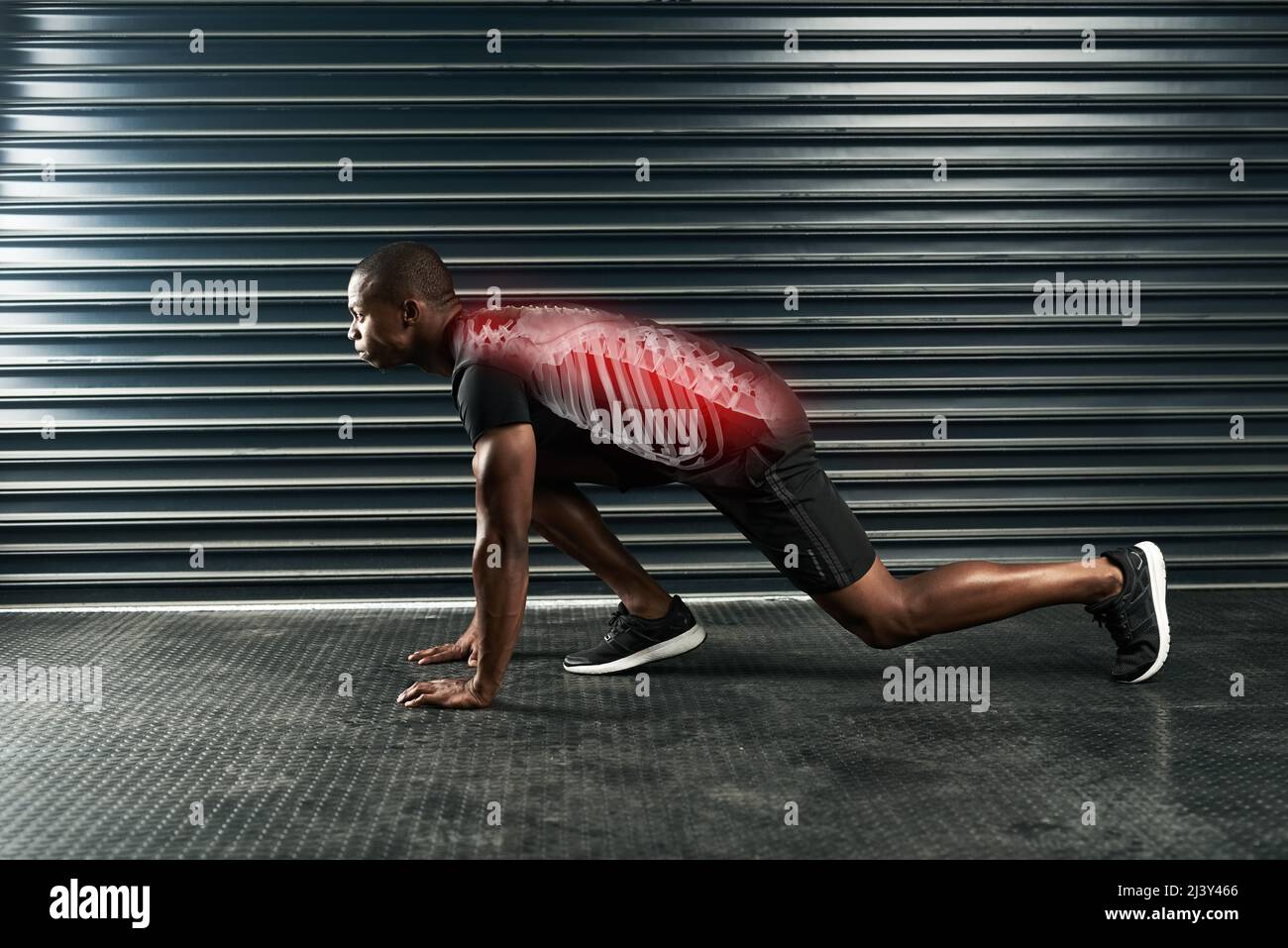 On his mark. Full length shot of an athletic young man ready on his ...