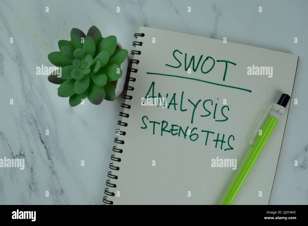 SWOT - Analysis Strengths write on a book isolated on Wooden Table ...