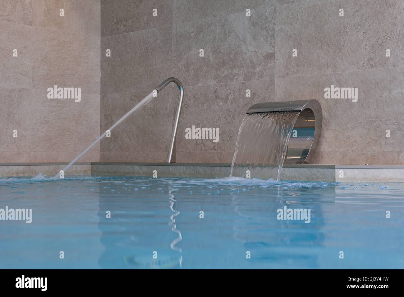Empty swimming pool with waterfall jet in action Stock Photo - Alamy