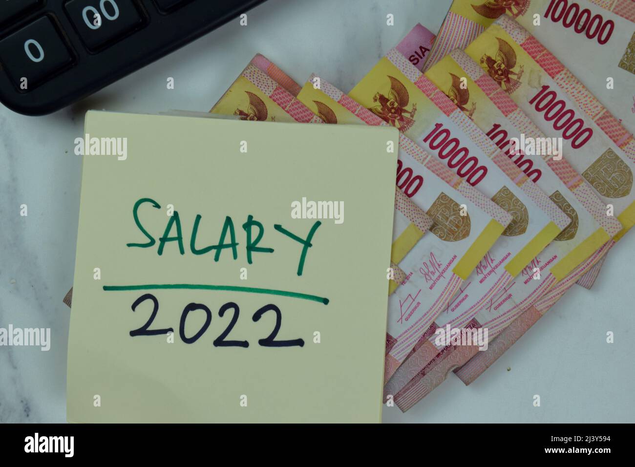 Salary 2022 write on sticky notes and Indonesian Currency isolated on ...