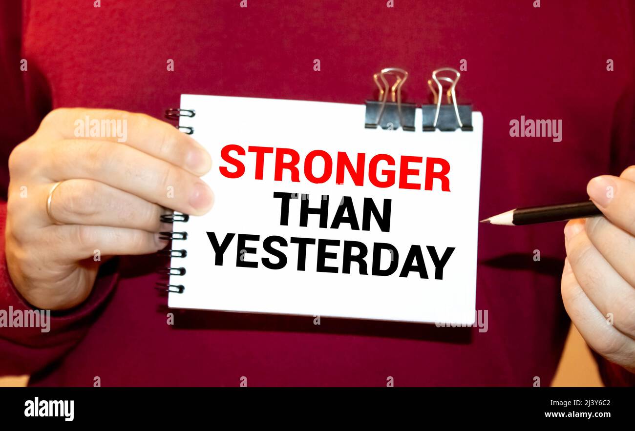 stronger than yesterday white chalk text on a vintage slate blackboard ...