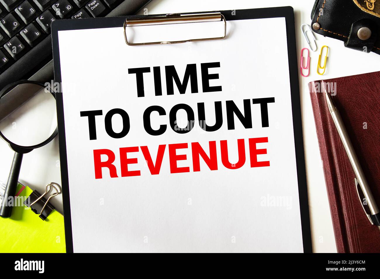 Text Time To Count Revenue on financial tables with pen, glasses and ...