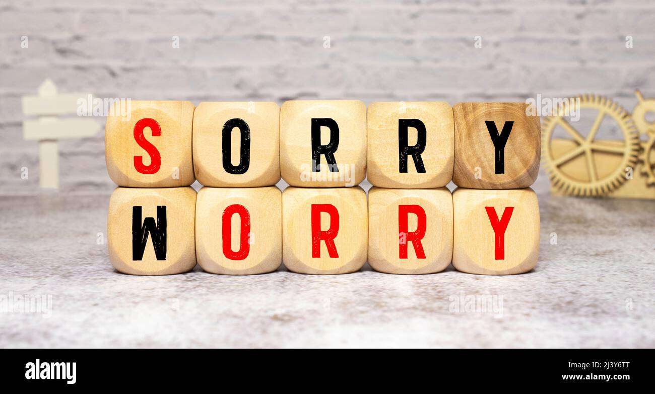 Sorry to worry. Hand turns a dice and changes the word worry to sorry ...