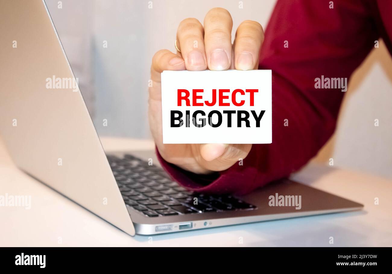 Text Prevent Bigotry written in blue under a wire mesh Stock Photo - Alamy