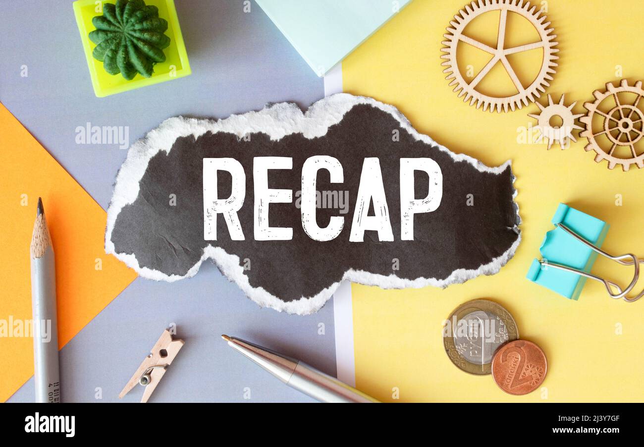 Recap - text on yellow note sheets on a dark wooden background with ...