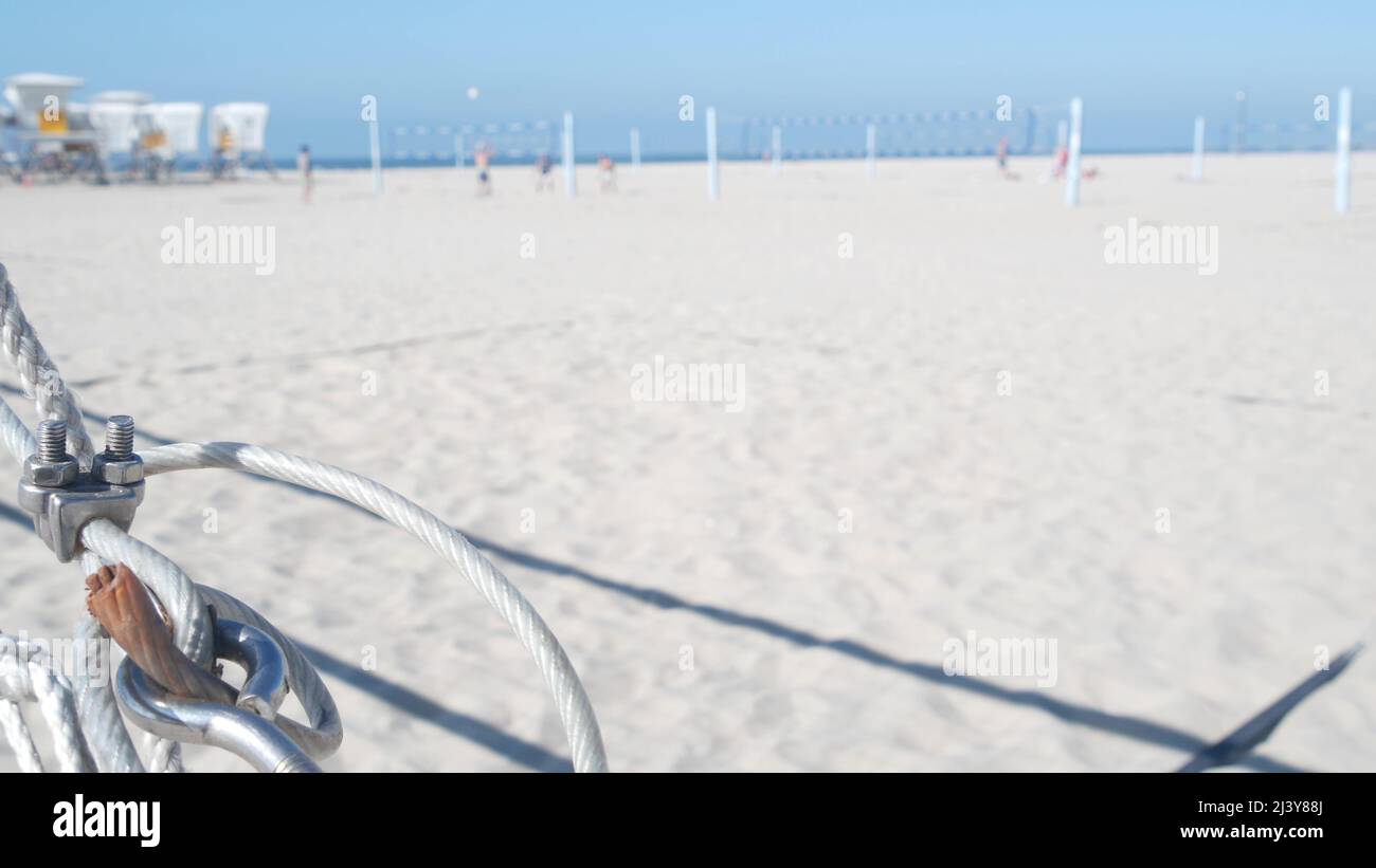 People playing volleyball on beach, lifeguard hut on California coast ...
