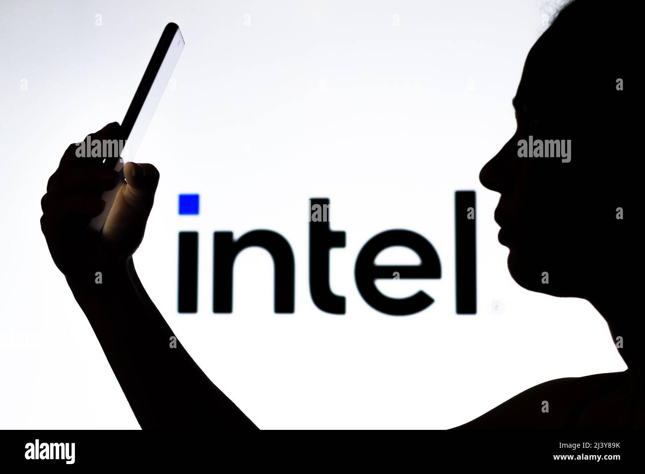 In this photo illustration, a woman's silhouette holds a smartphone ...