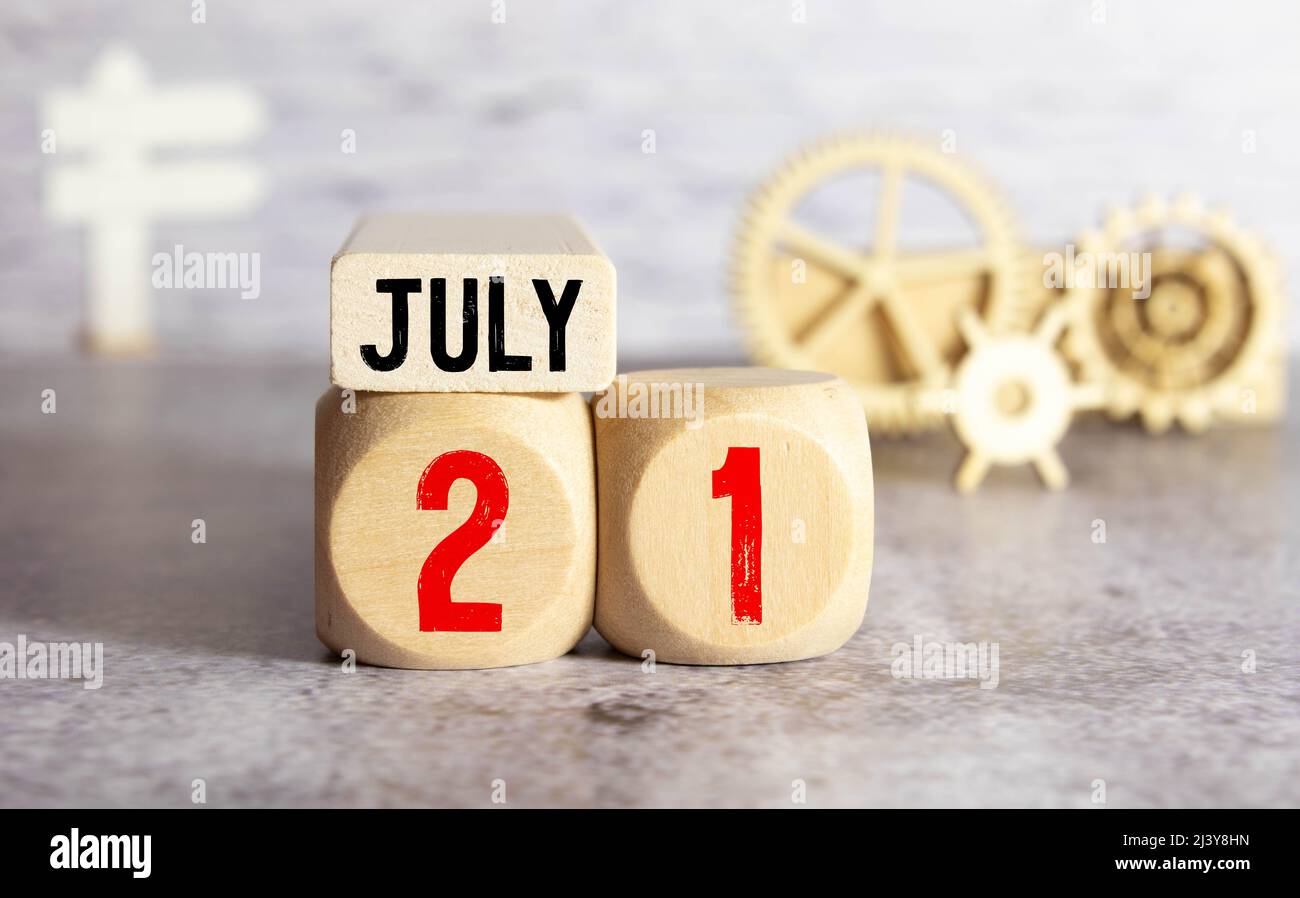 July 21. Date of July month. Number Cube with a flower and Sign wood on ...