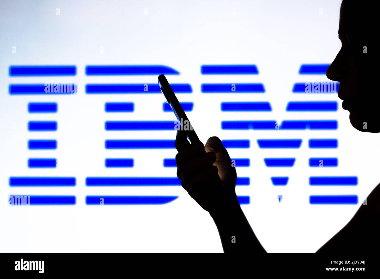 In this photo illustration, a woman's silhouette holds a smartphone ...