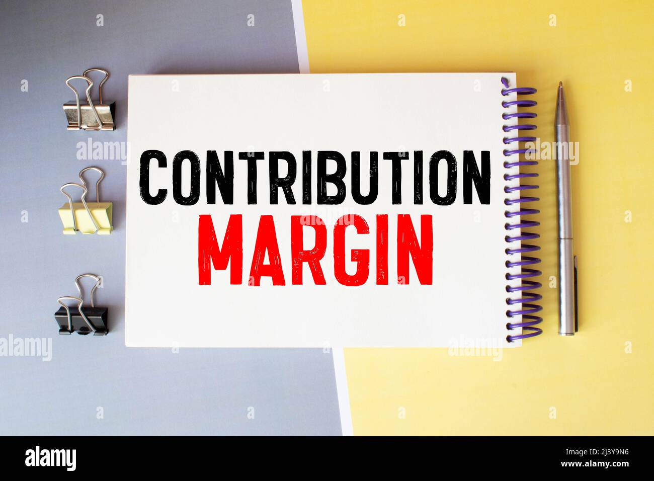 Text CONTRIBUTION MARGIN on Notebook and office tools on the gray ...
