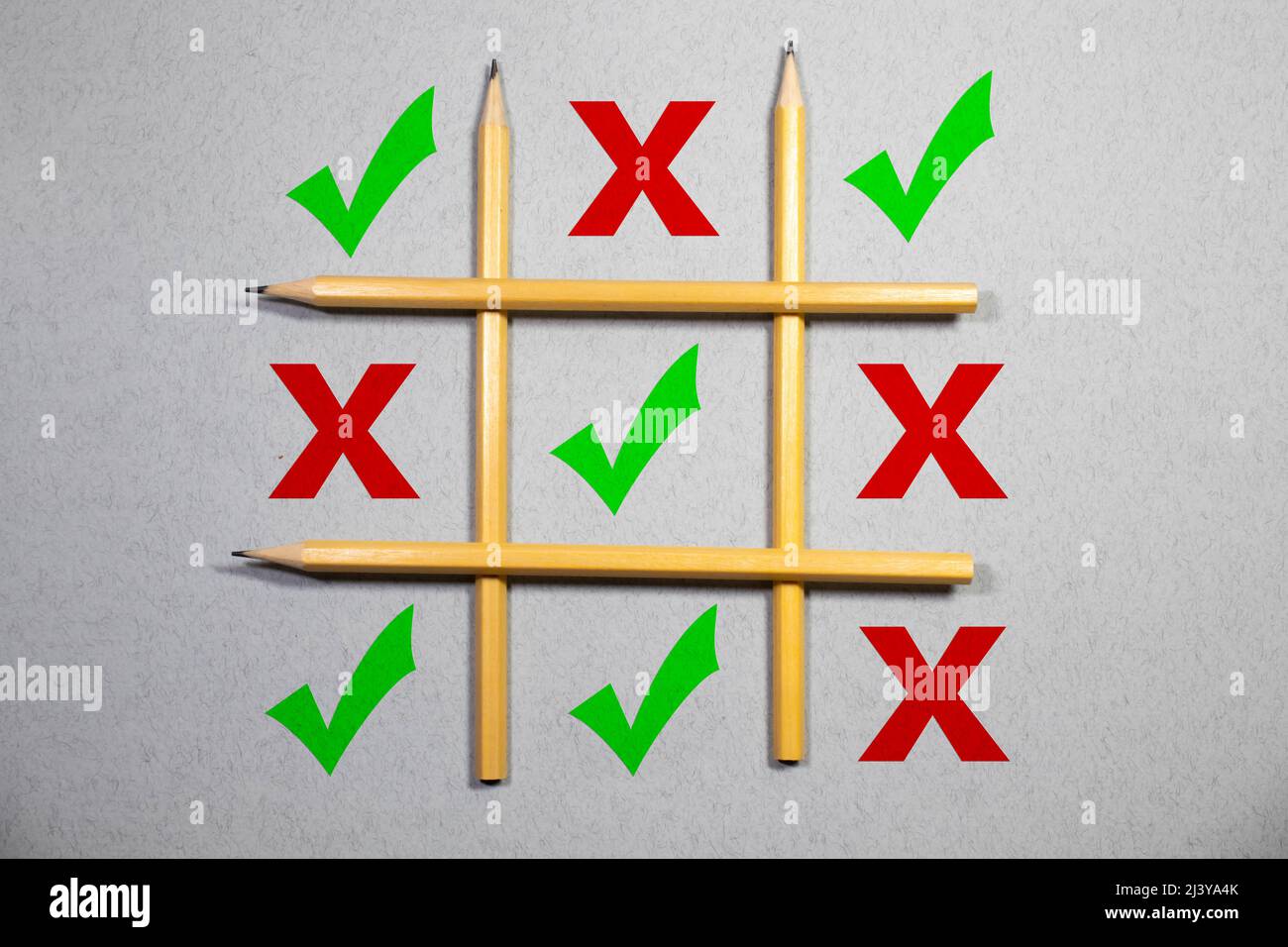 Hand writing YES or NO on note with marker pen and glasses on wooden ...