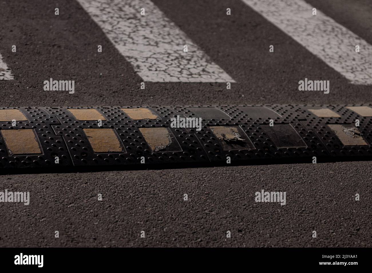 Traffic safety speed bump on an asphalt road. Traffic calming device ...