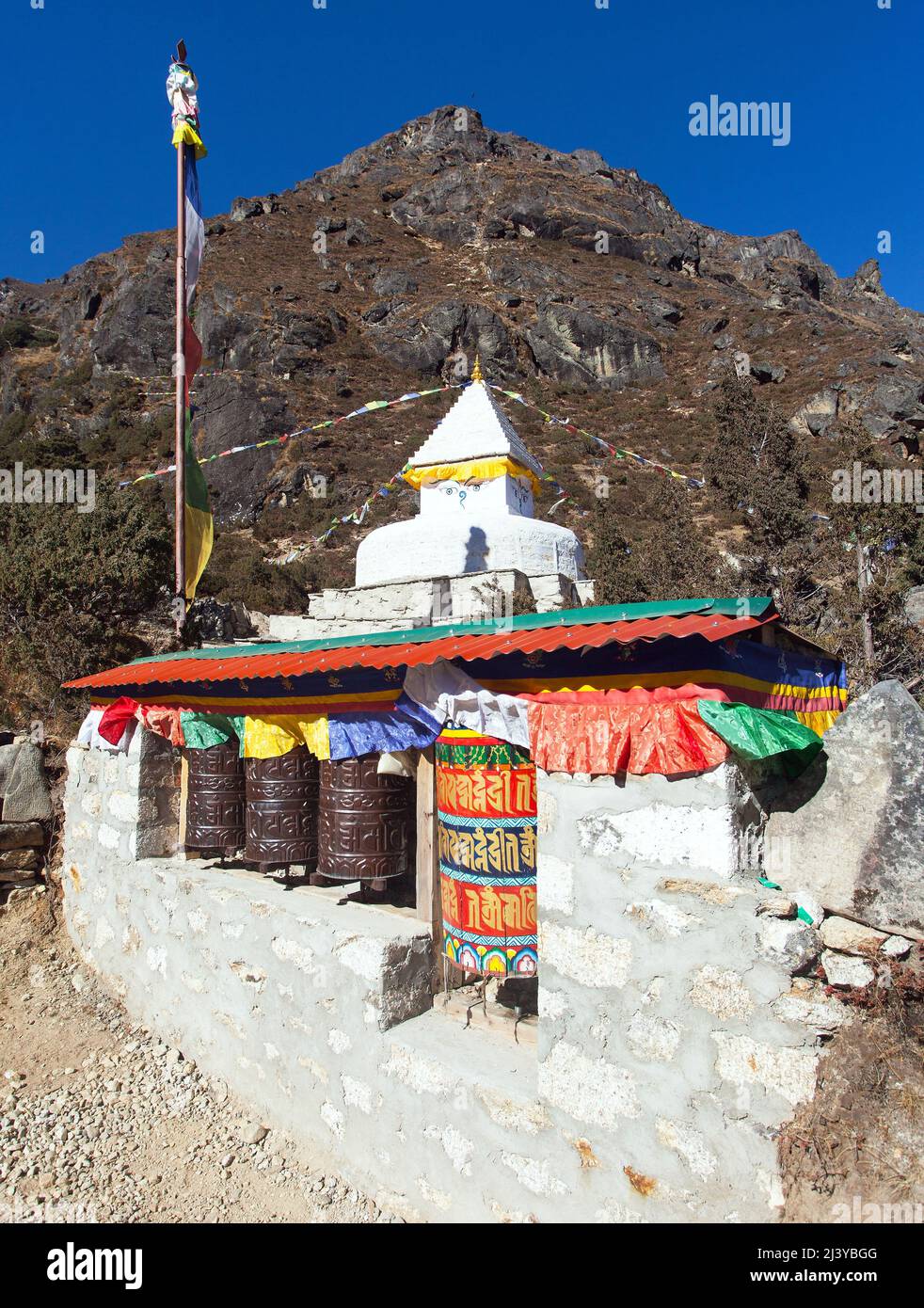Buddhist stupa and prayer wheel in Thame village, Khumbu valley on ...