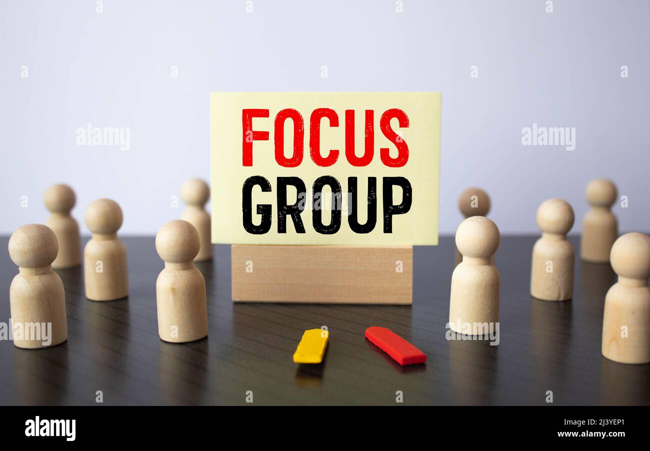 Focus group word handwritten on card posted on a cork board with red ...