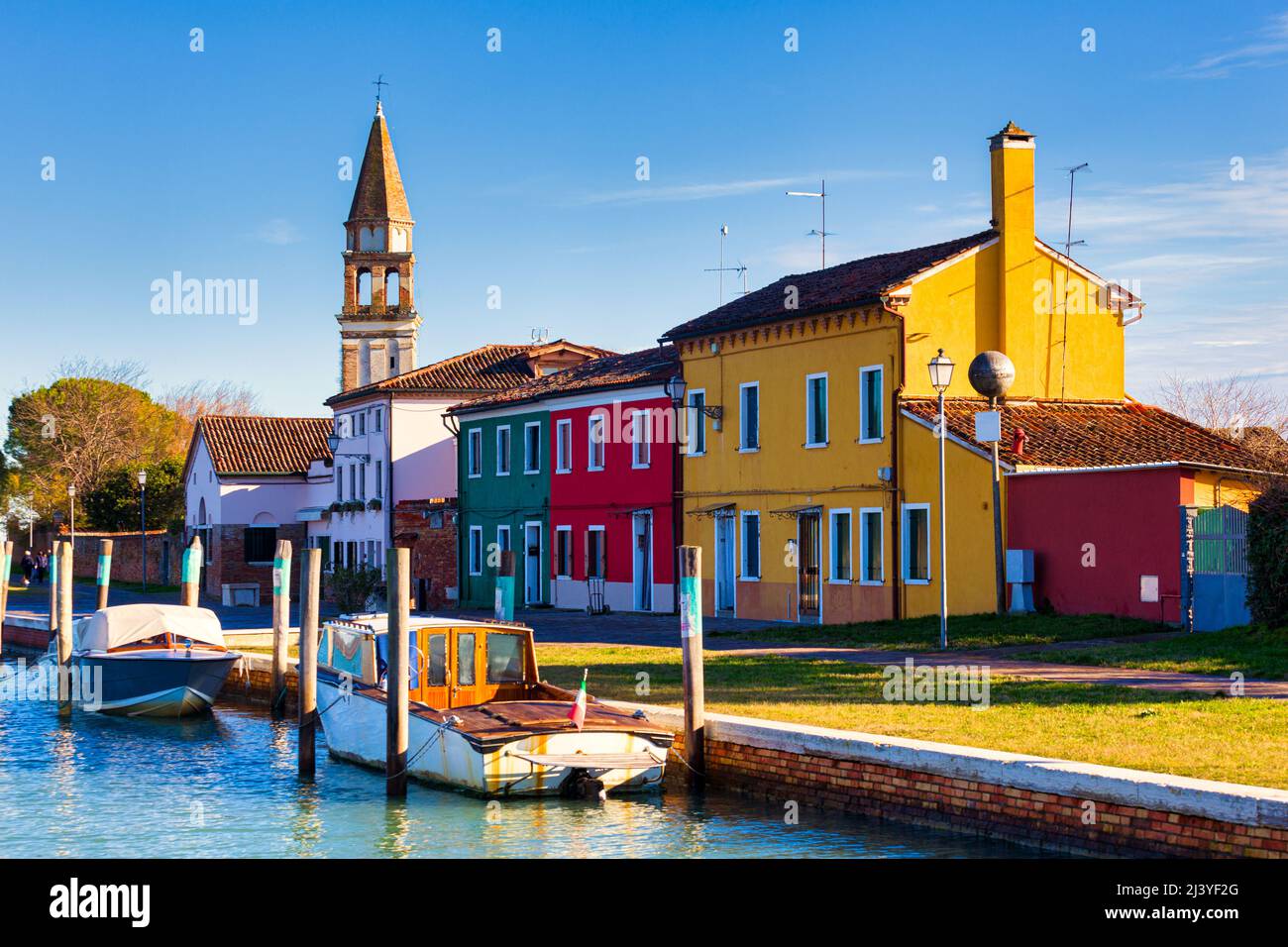 View of the San Michele Arcangelo bell tower and the colorful houses of ...
