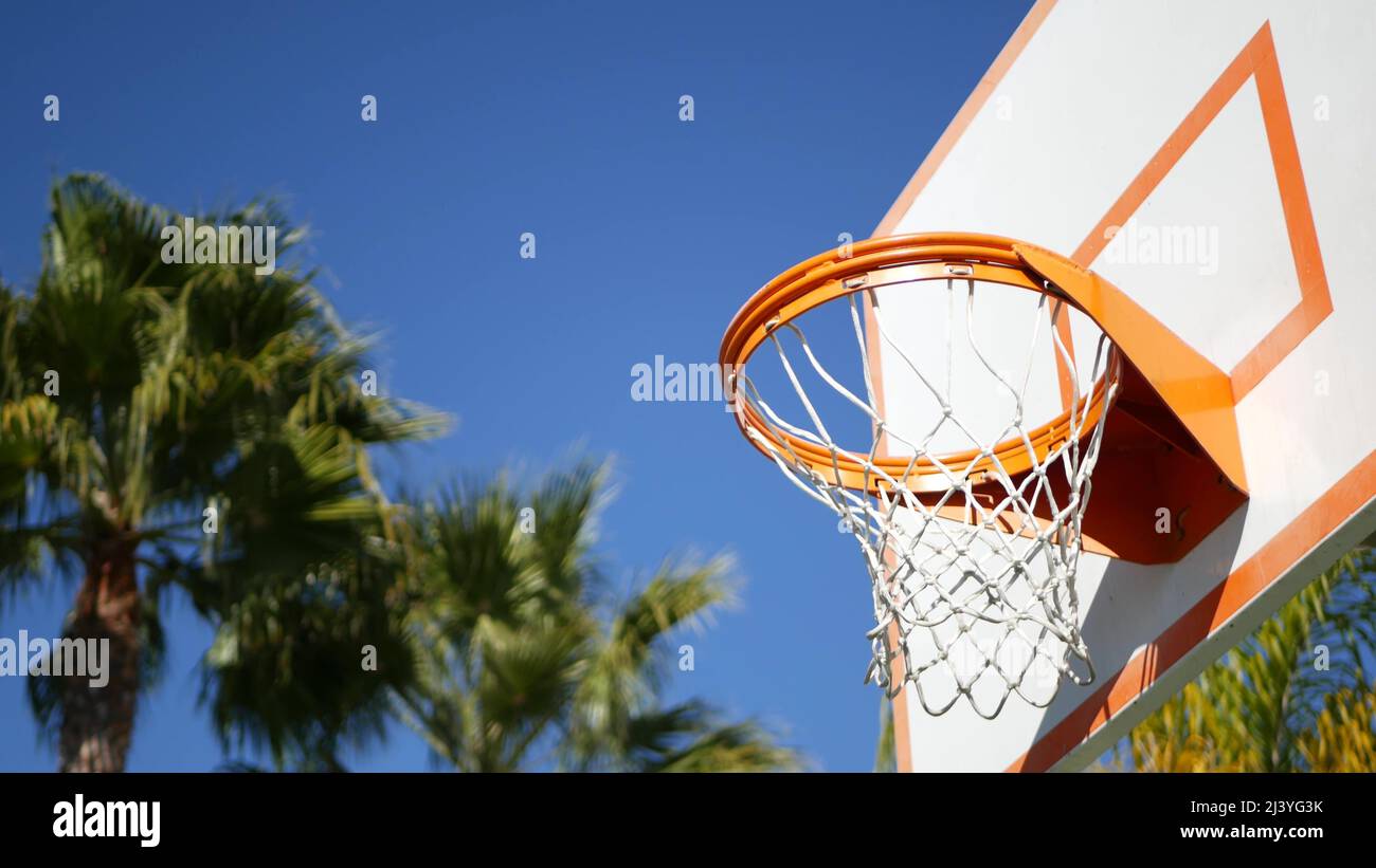 Basketball court outdoors, orange hoop, net and backboard for basket ...