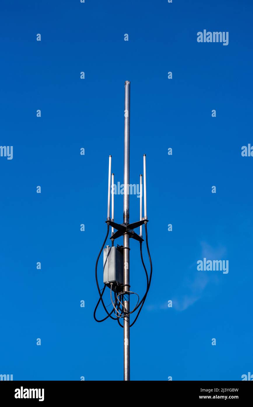 closeup of a small antenna system on a mast against a blue sky Stock ...