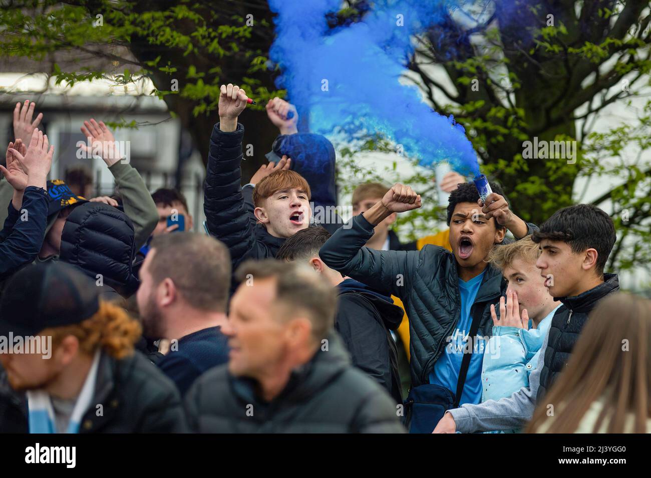 Manchester City fans set off smoke flares and sing different chants ...