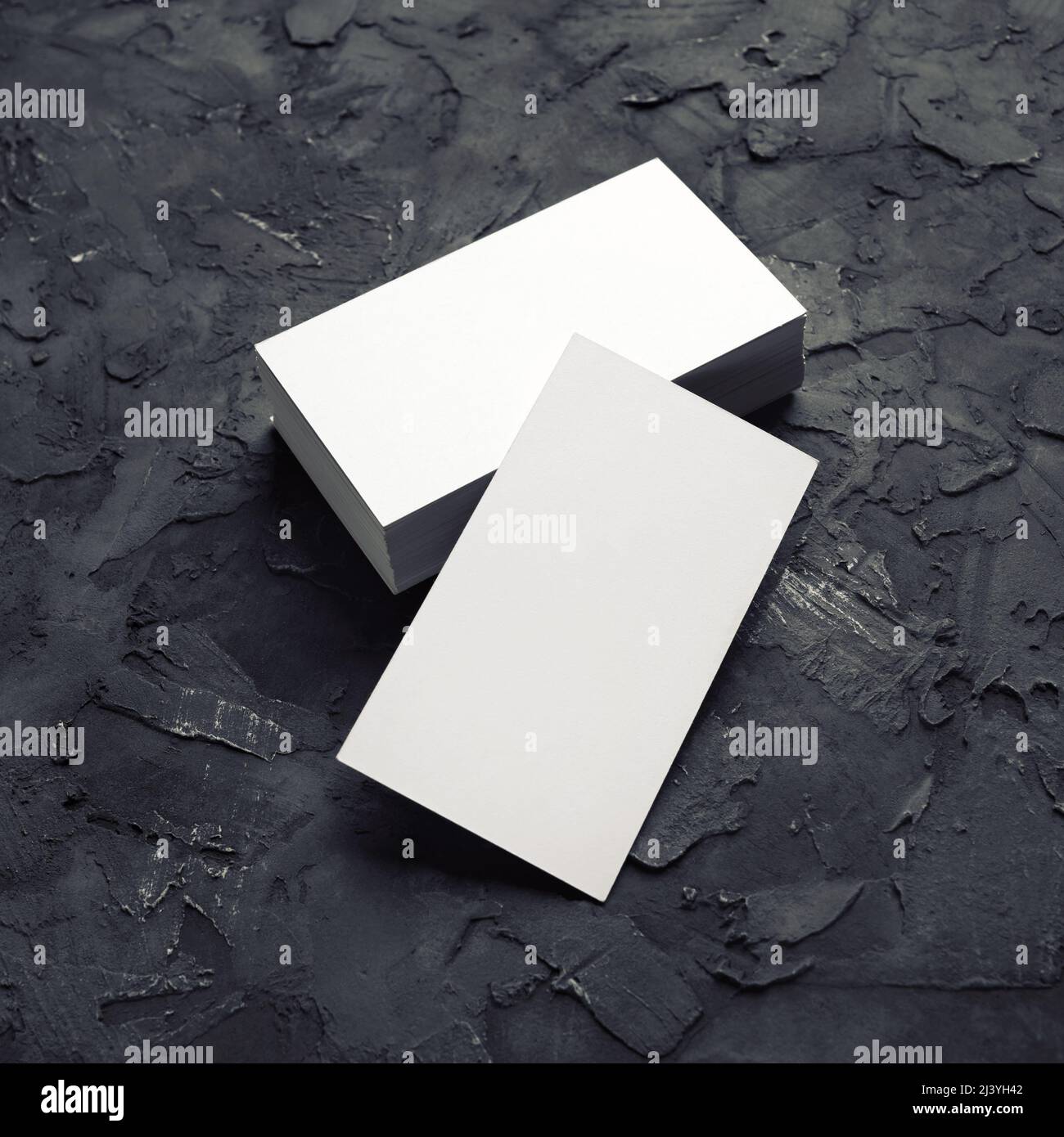 Blank white business cards on black plaster background. Mockup for ...