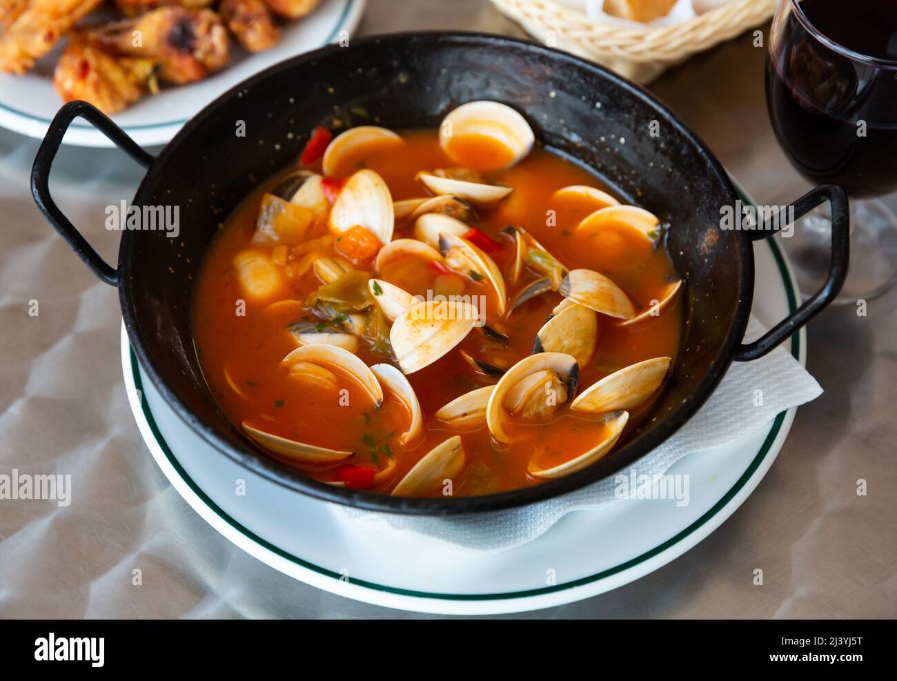 Red broth with bivalve mollusks Stock Photo - Alamy