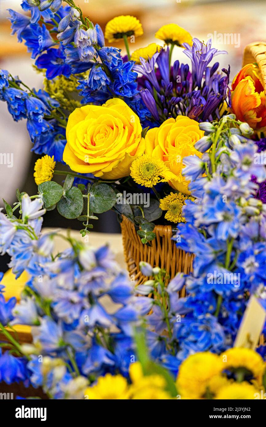 Yellow and blue flower arrangement for sale at a charity event to raise ...