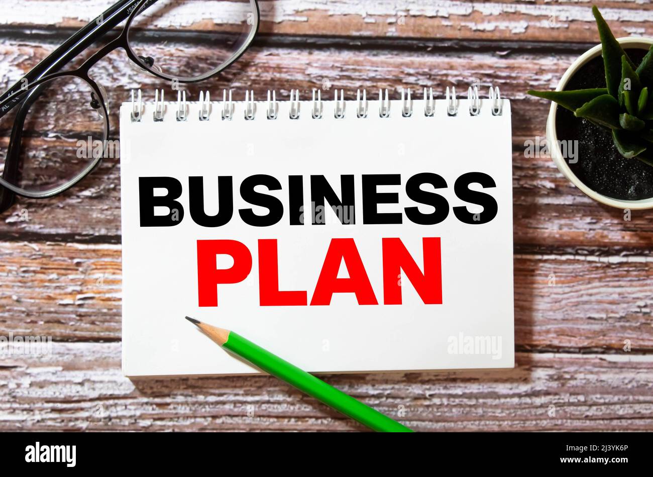 Business plan concept, on white paper Stock Photo - Alamy