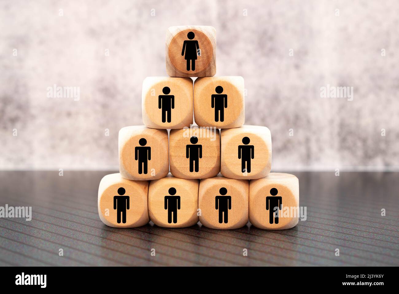 human resources manager is selecting a female worker atop a pyramid ...