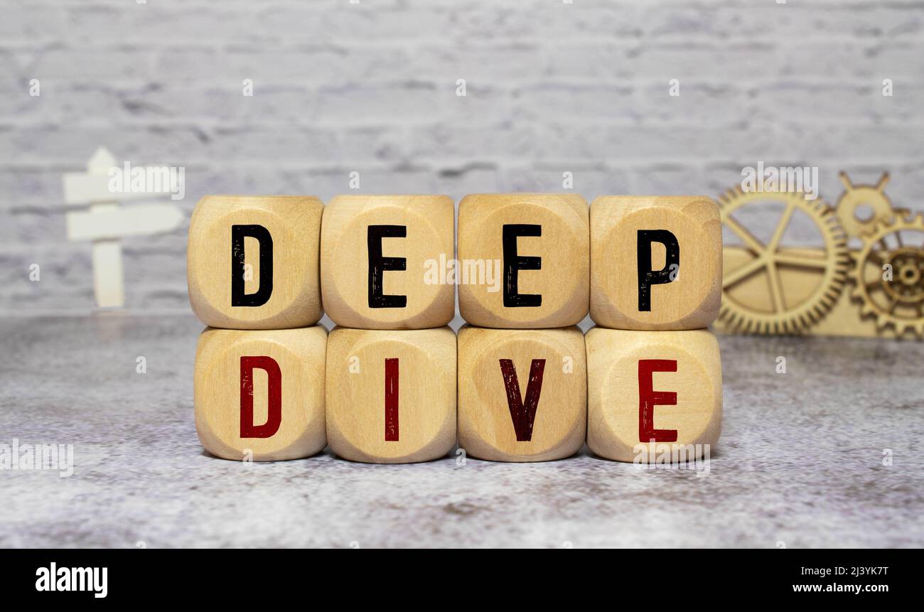 Modern business buzzword - deep dive. Top view on wooden table with ...